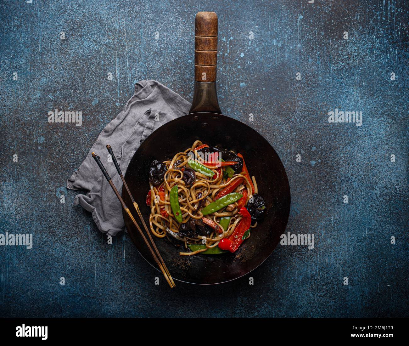 Asian stir fry noodles with vegetables in black wok pan Stock Photo - Alamy