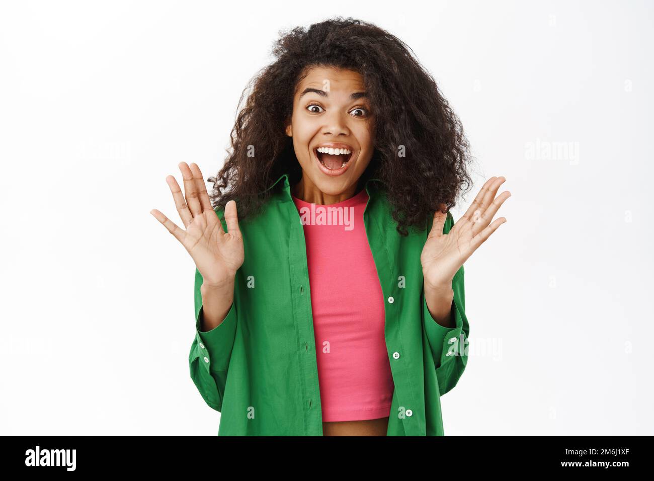 Excited Black woman jumping from happiness and joy, smiling and ...