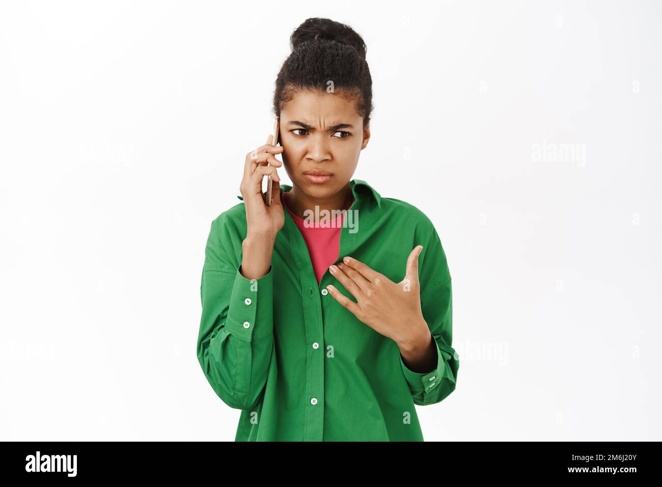 Shocked woman answers phone call. Girl talks on mobile with worried and ...