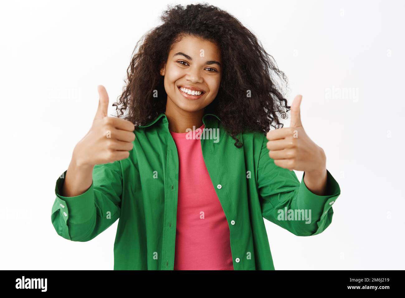 Smiling Black woman shows thumbs up, like and recommend smth, say yes ...
