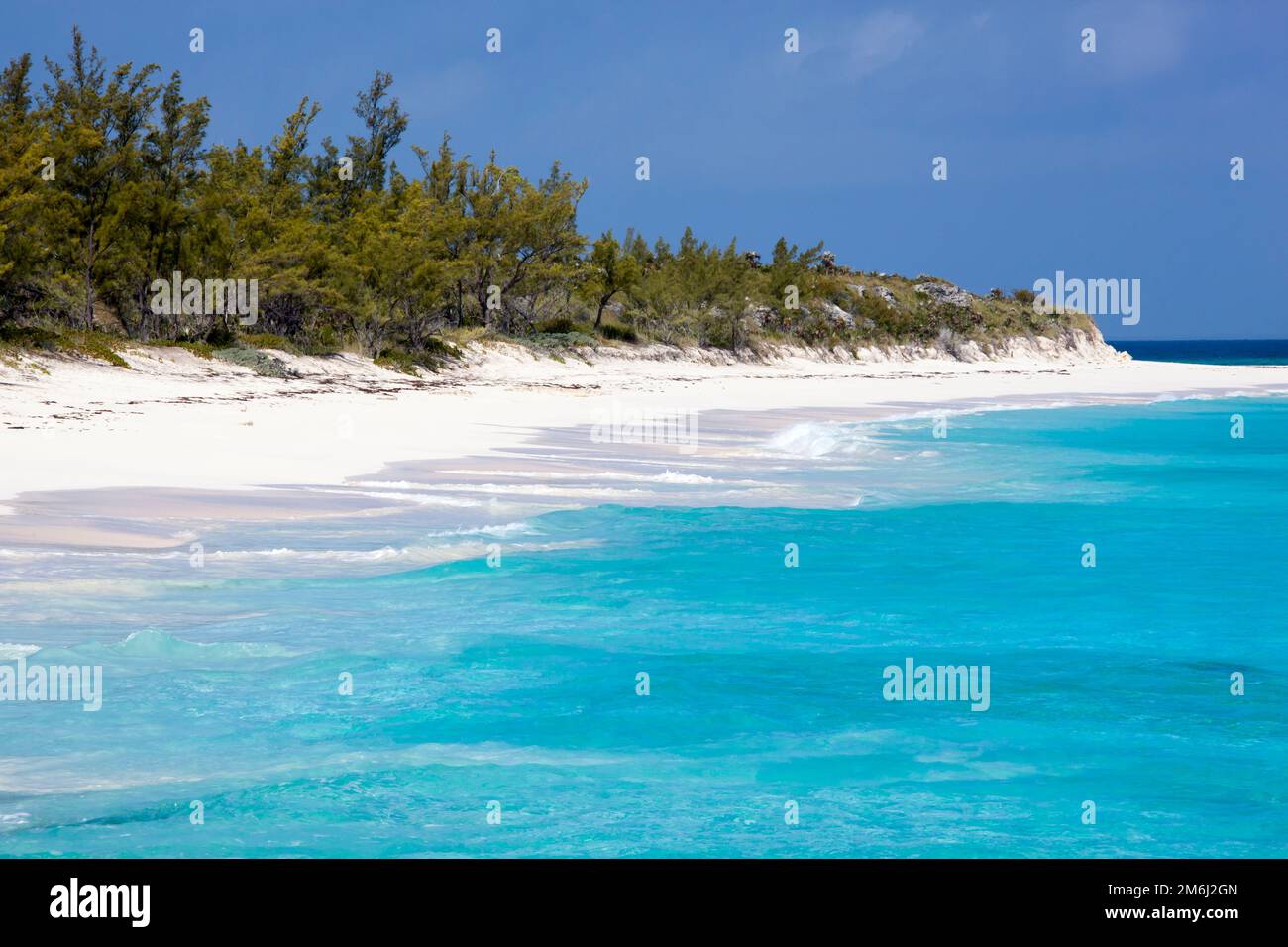 The scenic view of turquoise color waves and a sandy empty beach on ...