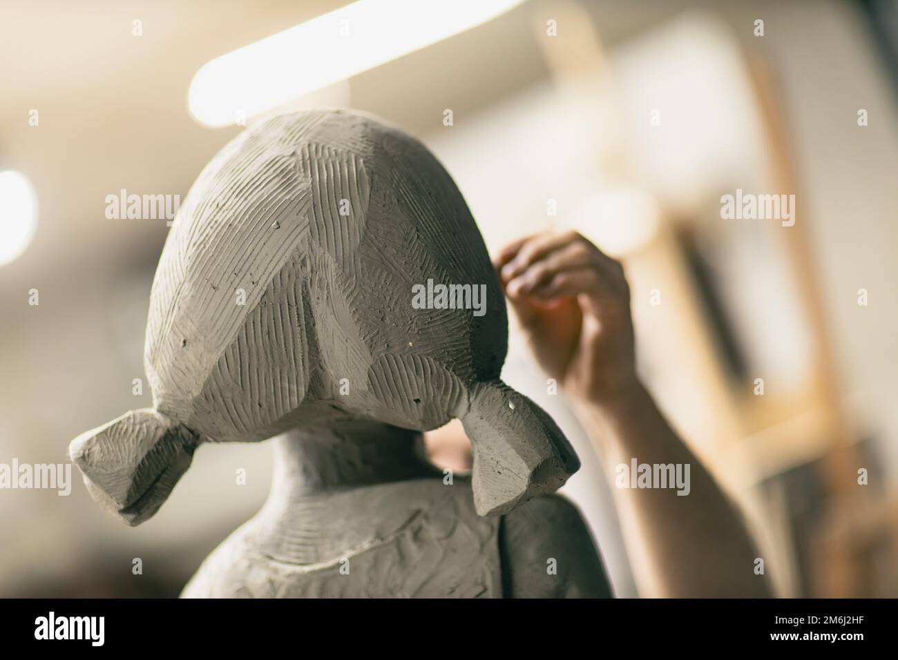 Man sculptor creates sculpt bust clay human woman sculpture. Statue ...