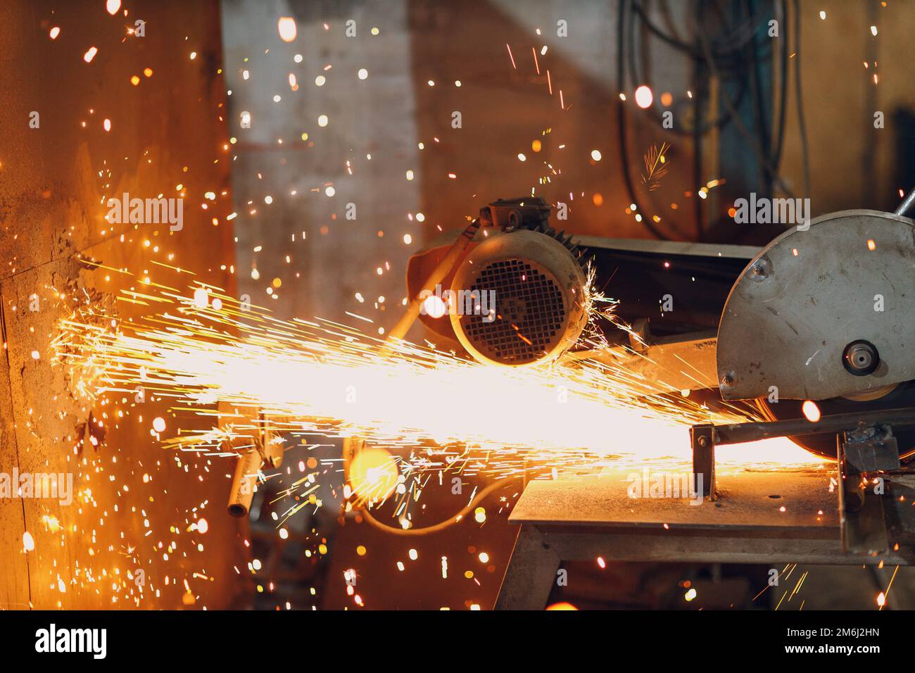 Metal processing with compound mitre saw with circular blade. Sparks in ...