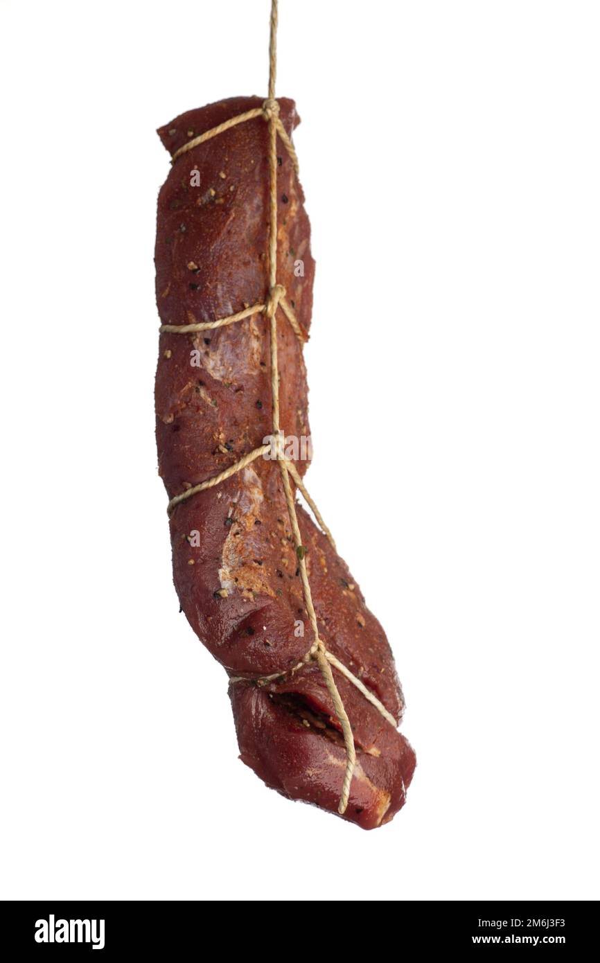 Hanging raw pork tenderloin on white Stock Photo - Alamy