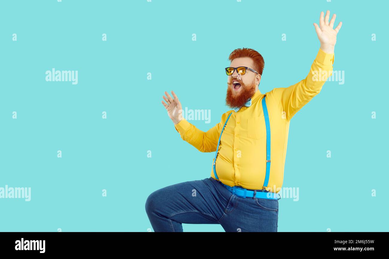 Funny fat man having fun at crazy party and dancing on turquoise copy ...