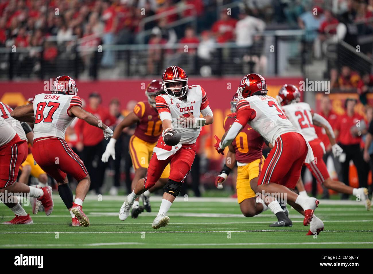 Utah Utes quarterback Cameron Rising (7) hands the ball of to Utah Utes ...