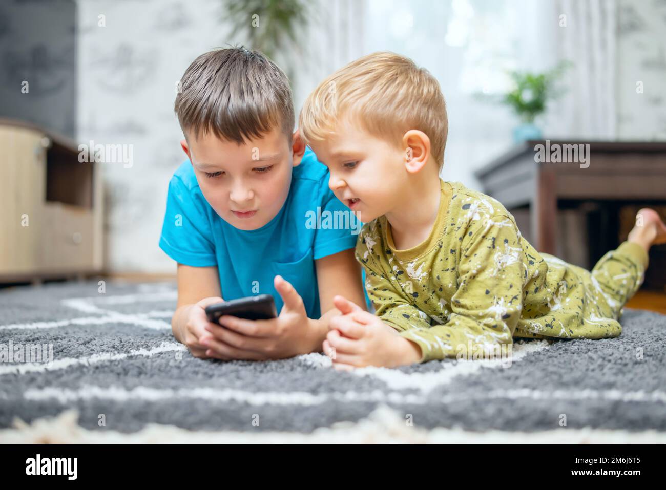 Two children watching smart phone, happy kids using smartphones ...