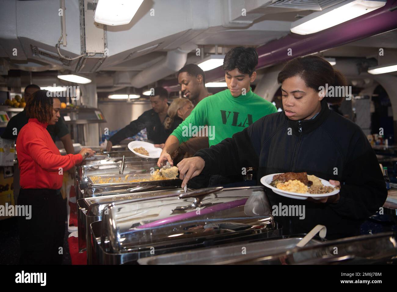 PHILIPPINE SEA (April 27, 2022) Sailors serve themselves food on the ...