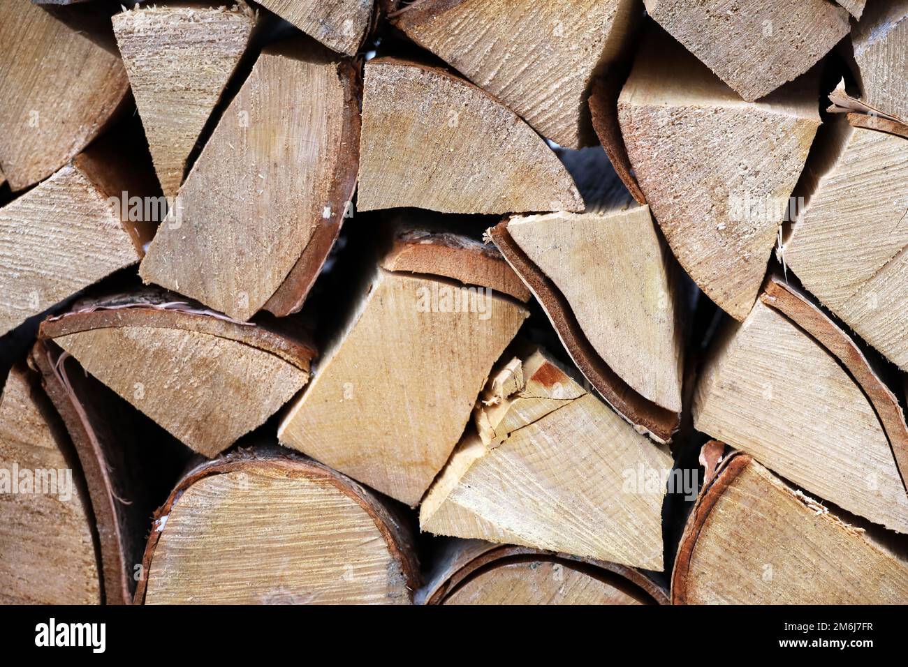 Chopped firewood in the woodpile. Stack of wood on winter street Stock ...