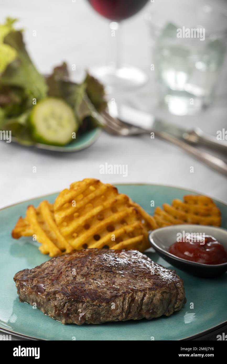 Grilled steak with fresh potato grids Stock Photo - Alamy
