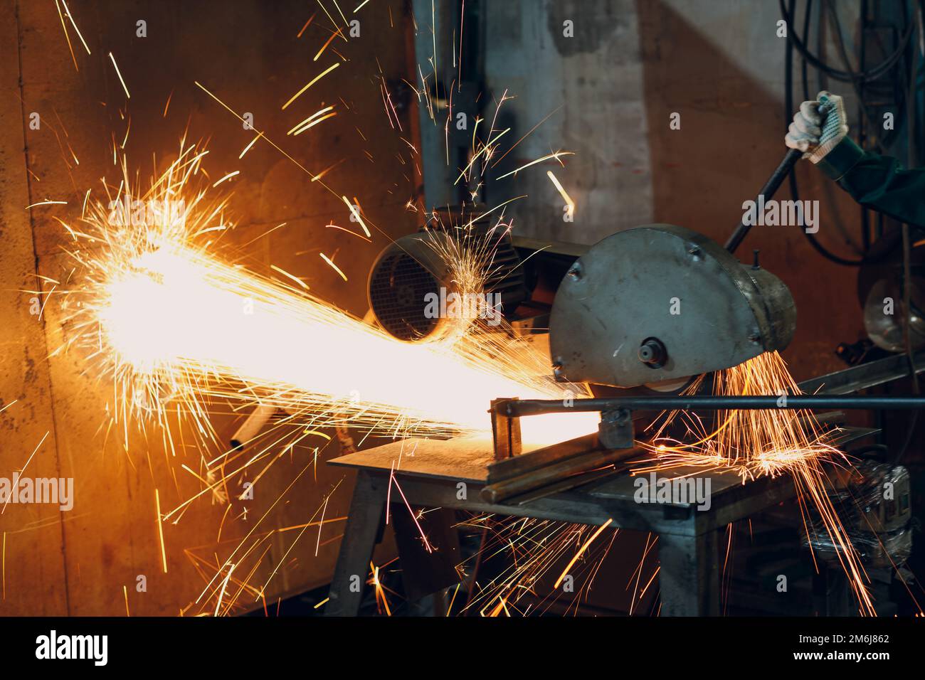 Metal processing with big angle grinder disk saw. Sparks in ...