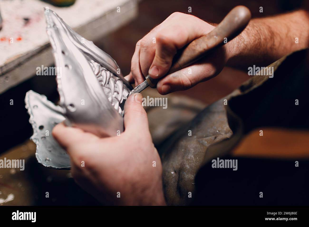 Artisan craftsman create mask based on plaster cast. Gypsum mold and ...