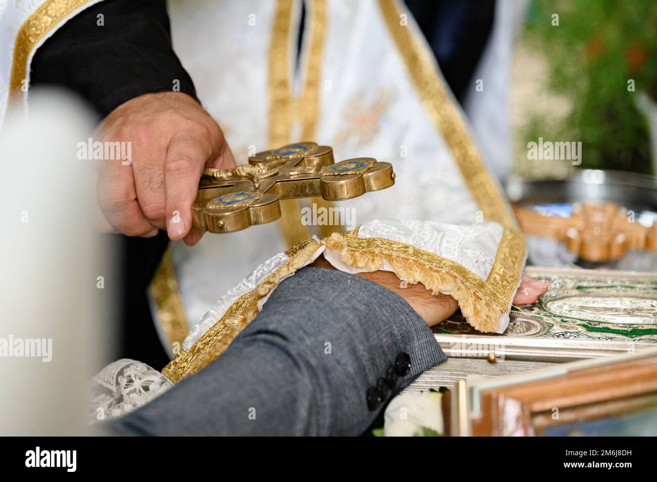 The bride and groom put their hands on the gospel for the oath, the ...