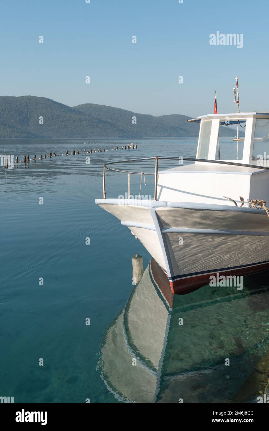 Stunning view of a boat moored in the beautiful harbour of Turkish ...