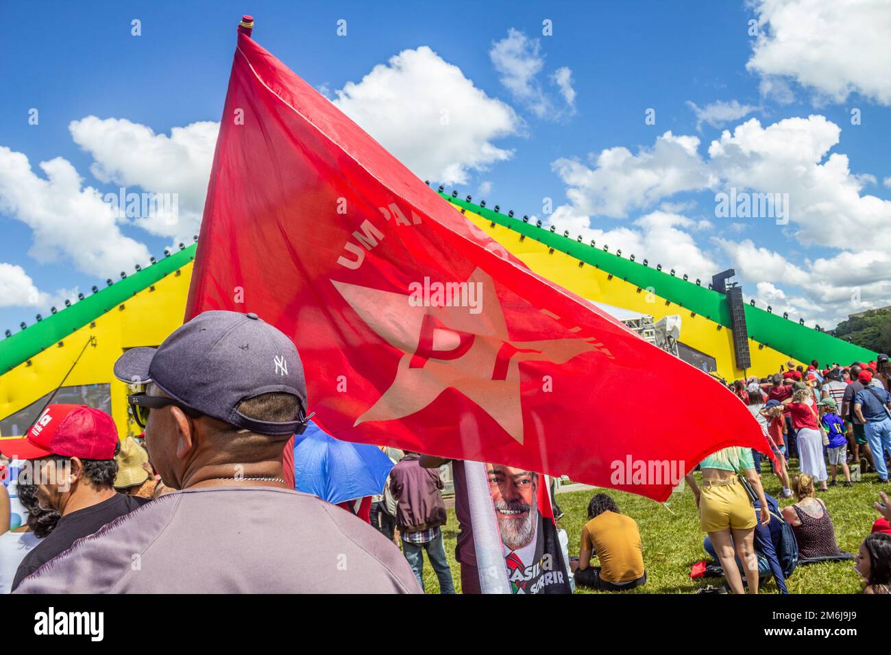 Brasília, DF, Brazil – January 01, 2023: A person waving a giant red ...