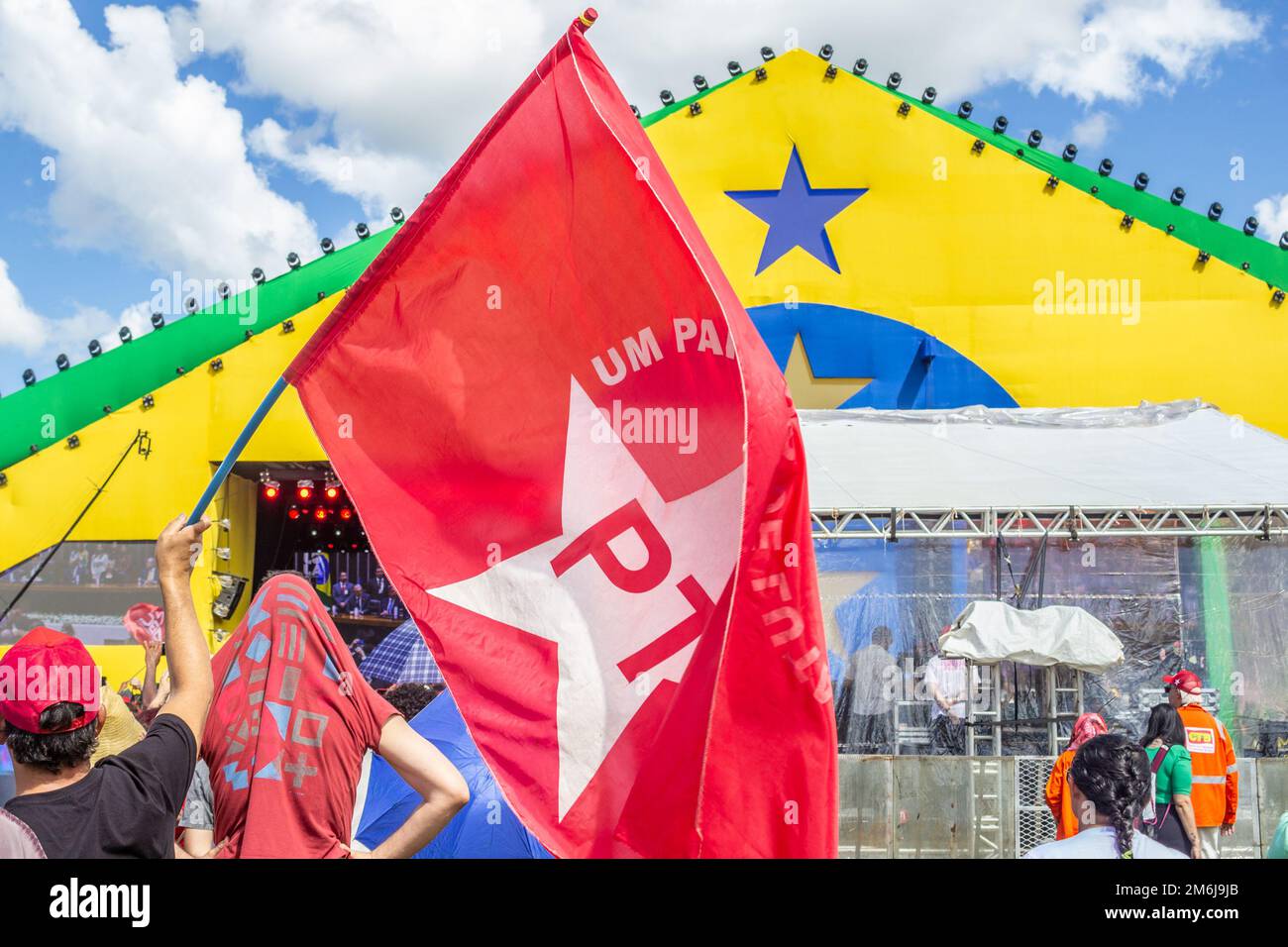 Brasília, DF, Brazil – January 01, 2023: A person waving a giant red ...