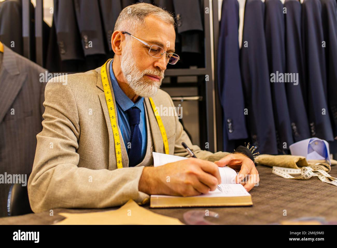 elderly good looking man in stylish and rich suit owner of atelier ...