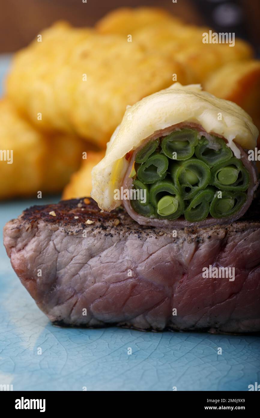 Slice of steak on a blue plate Stock Photo - Alamy