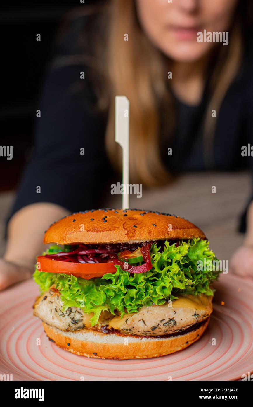 Closeup plate with juicy appetizing chicken burger isolated on waiter ...