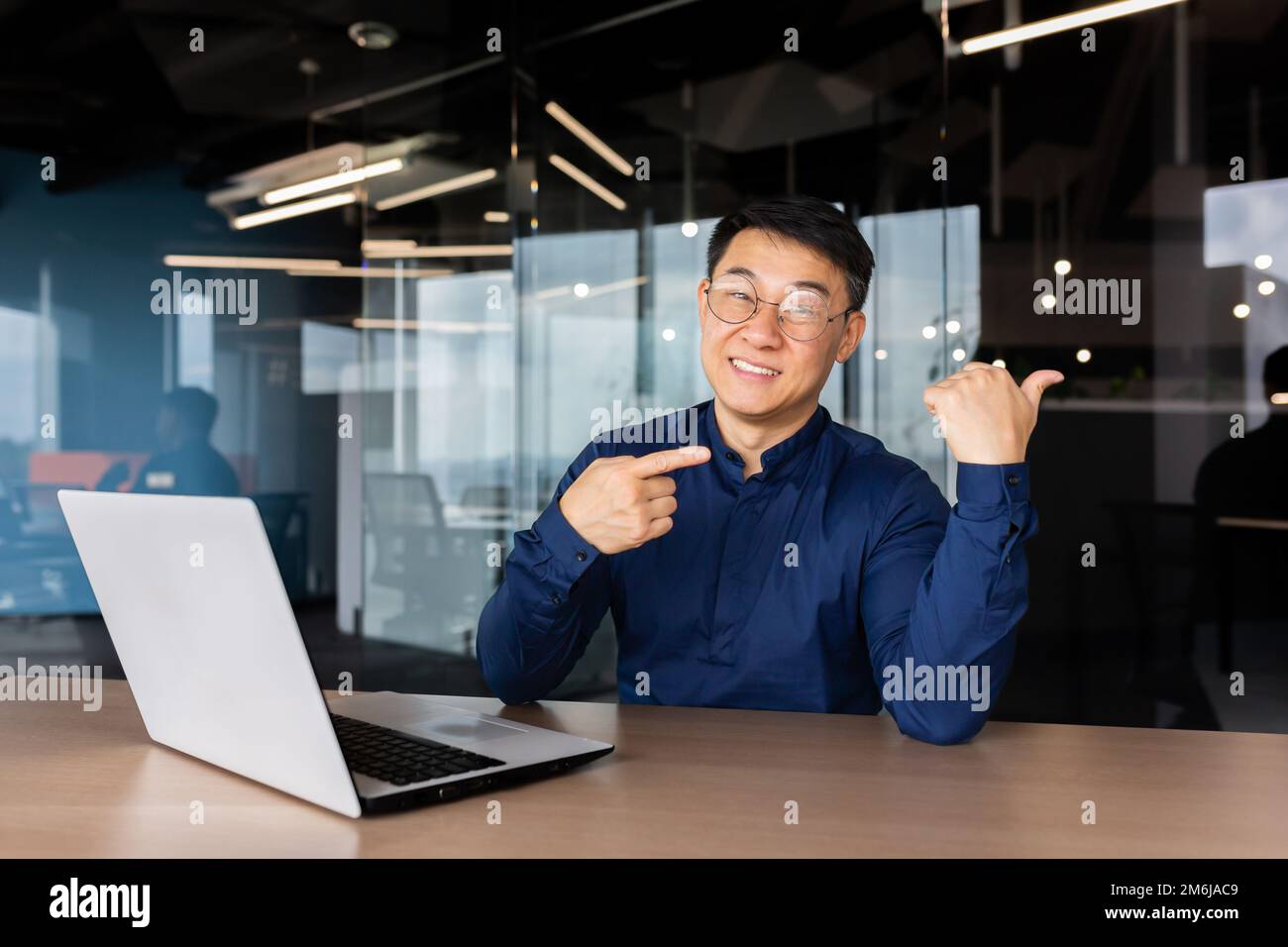 Smiling investor pointing laptop hi-res stock photography and images ...