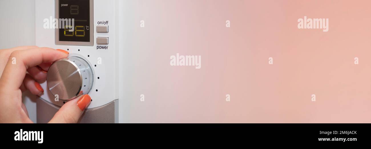 Gas boiler. A woman regulates the temperature with a temperature ...