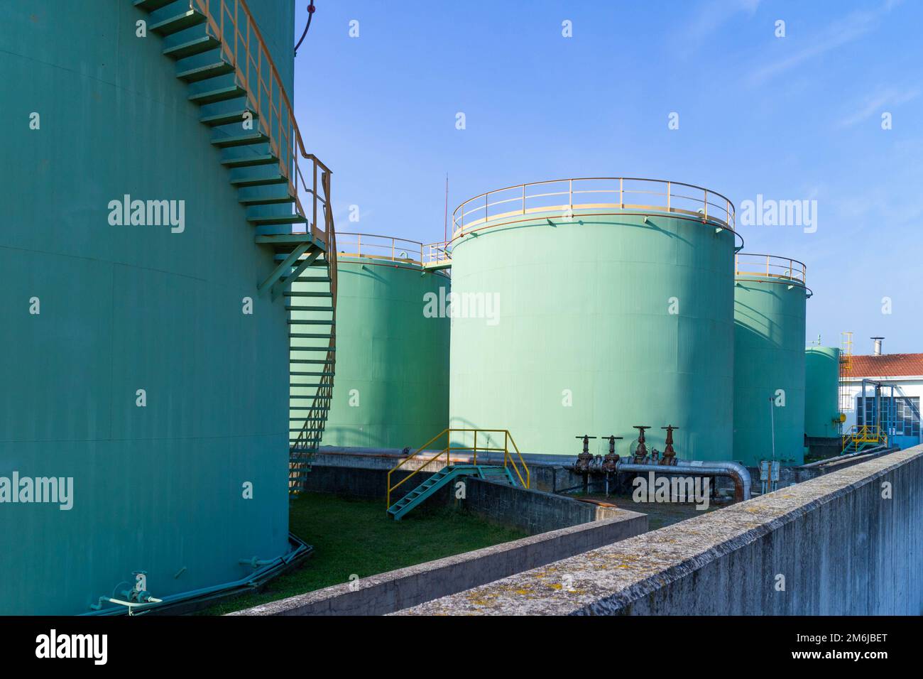 View of storage tank and pipes of chemical industry, Italy Stock Photo ...