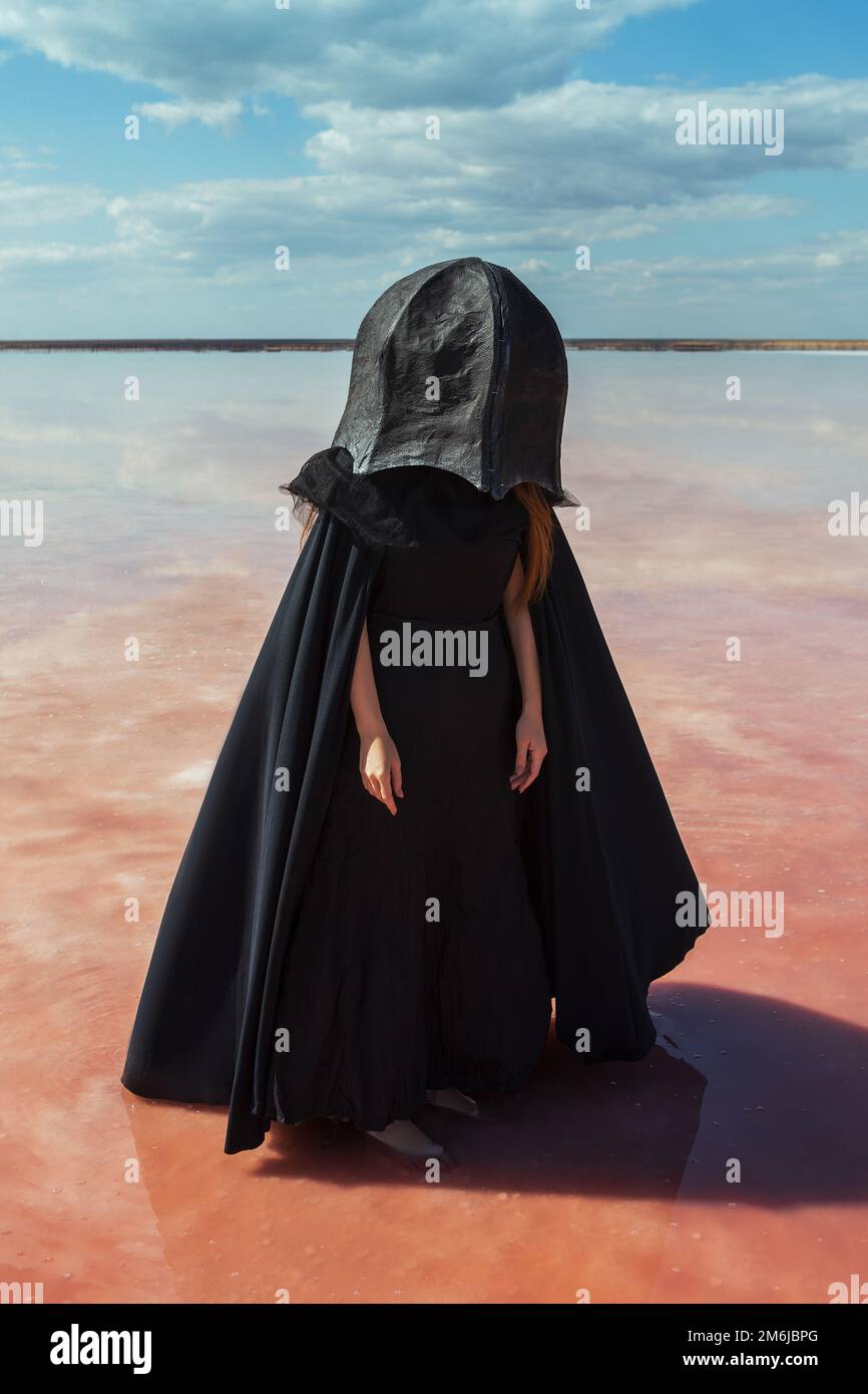 woman in a black wear on a pink lake Stock Photo - Alamy
