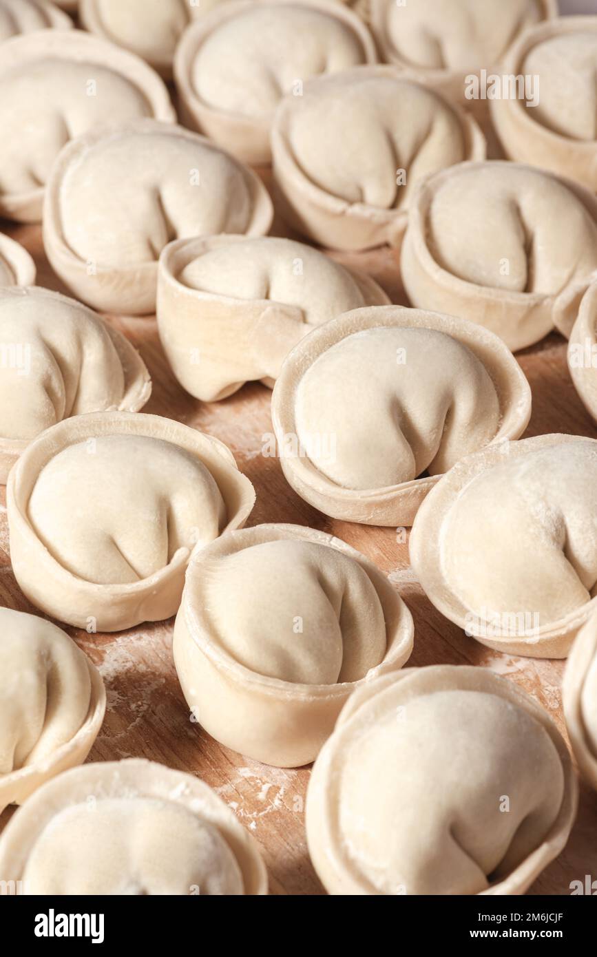 Fresh hand made dumplings ready to cooking on board Stock Photo - Alamy