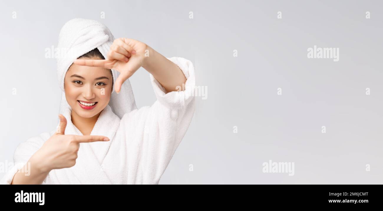 Beautiful Woman face and she making frame with hands with health skin ...