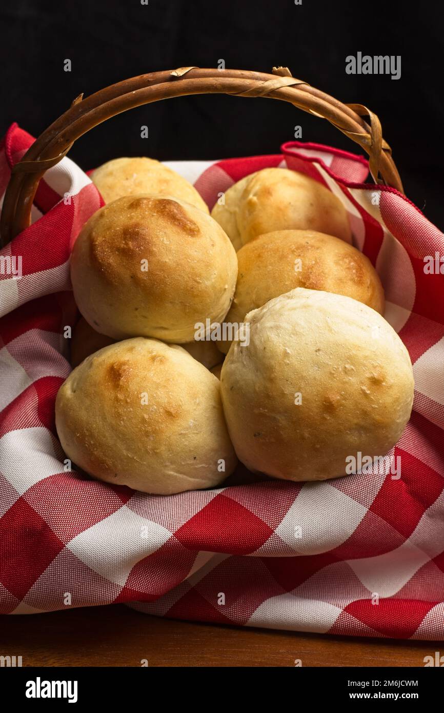 A close up photo of a small basket with a red and white napkin of baked ...