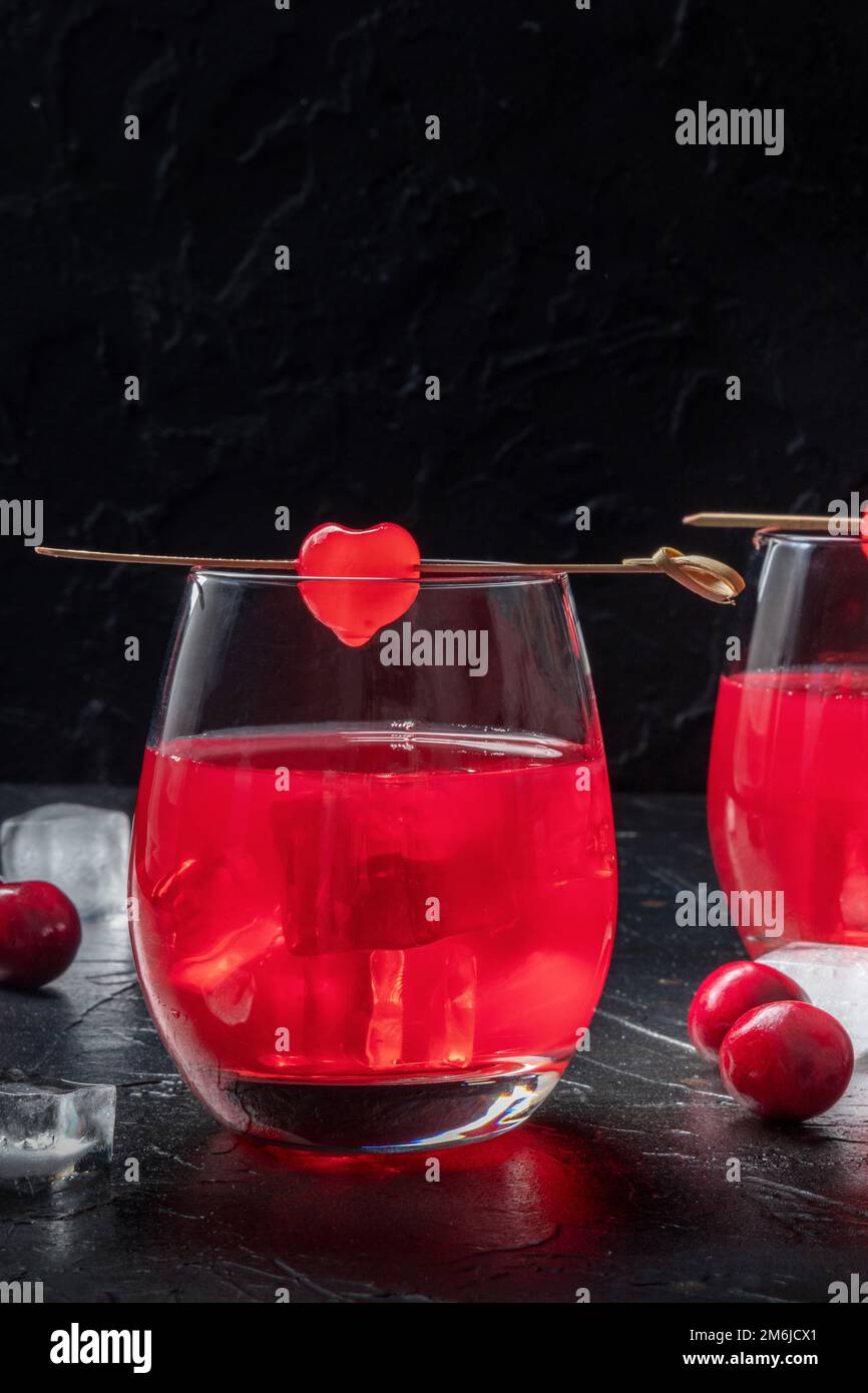 Cocktail cherry and a mocktail on a dark background, a vibrant red ...