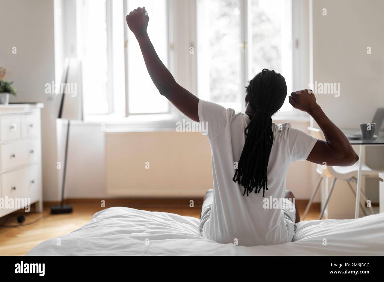 Man sitting in bed stretching hi-res stock photography and images - Alamy