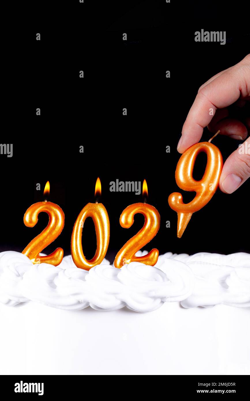 Golden candles write numbers flame Happy new year 2029 hand Stock Photo ...