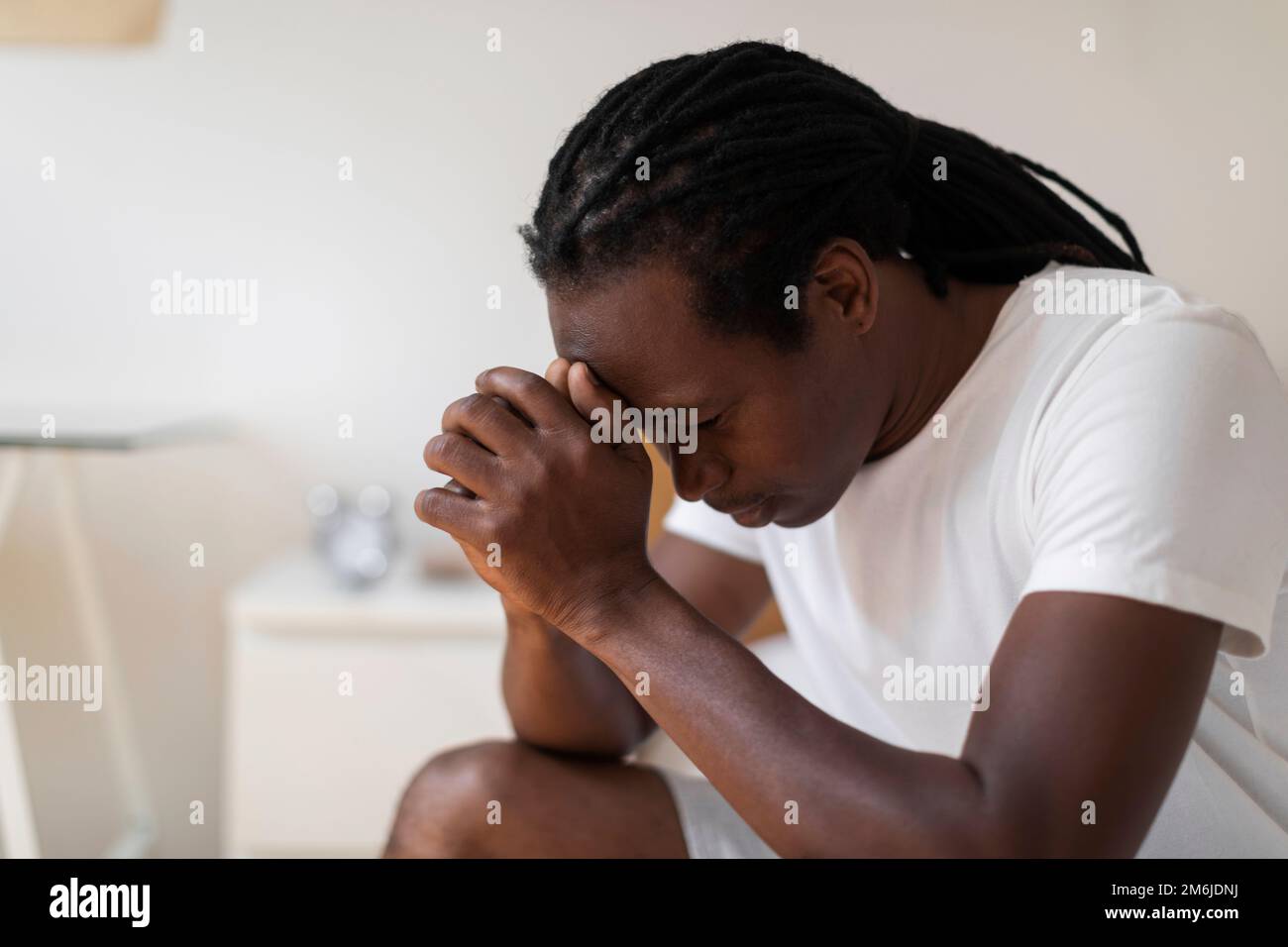 Depression Concepr. Closeup Of Upset Black Man Sitting On Bed At Home ...