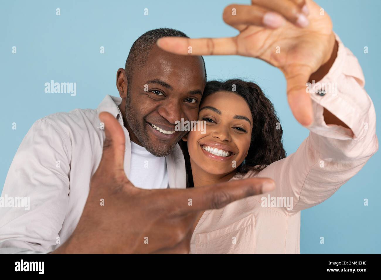 Capturing moments. Close up portrait of black couple making picture ...