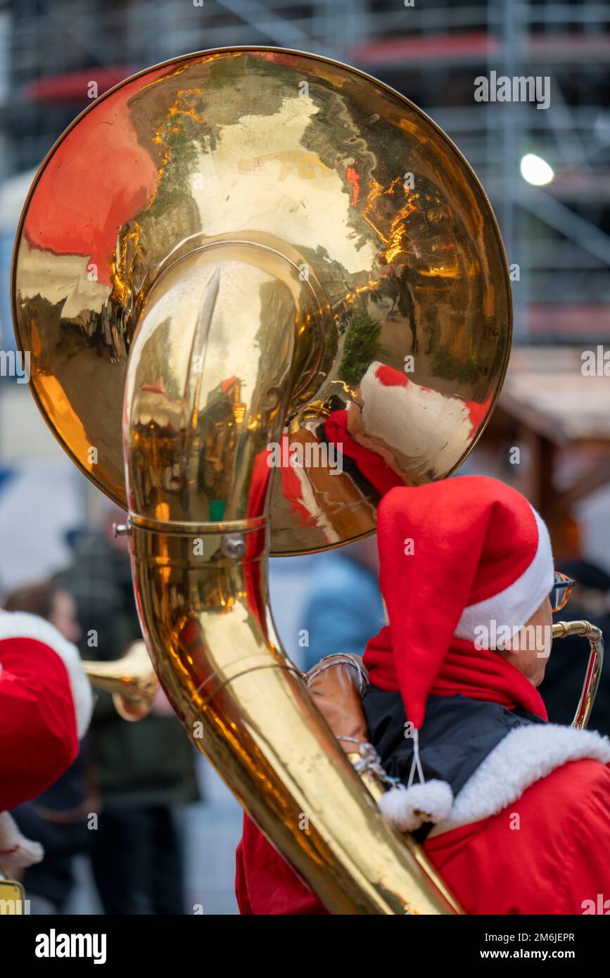 Pre-Christmas period, street musician in Father Christmas costume ...