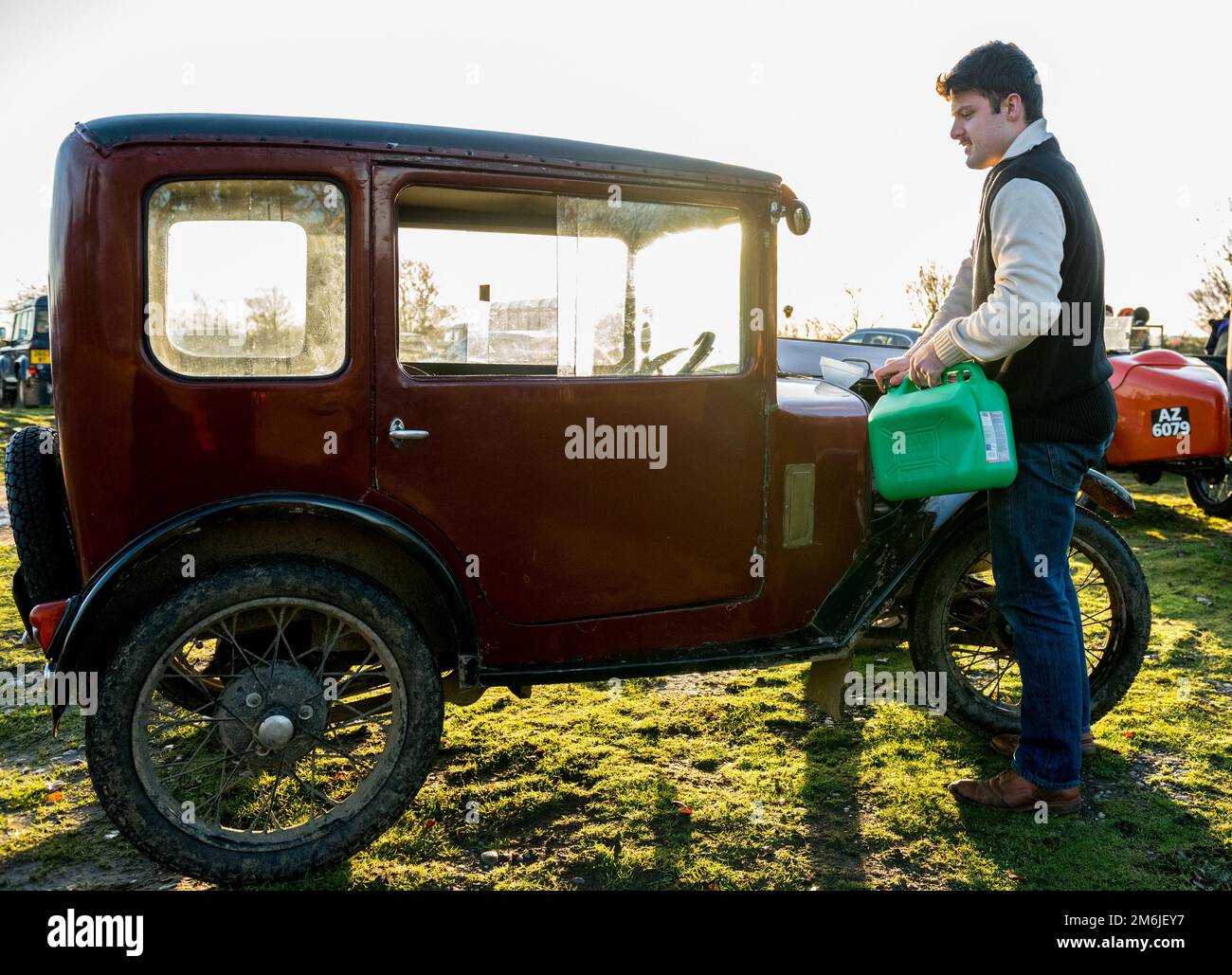 The Pre War Austin 7 car club member preparing his car and filling the ...
