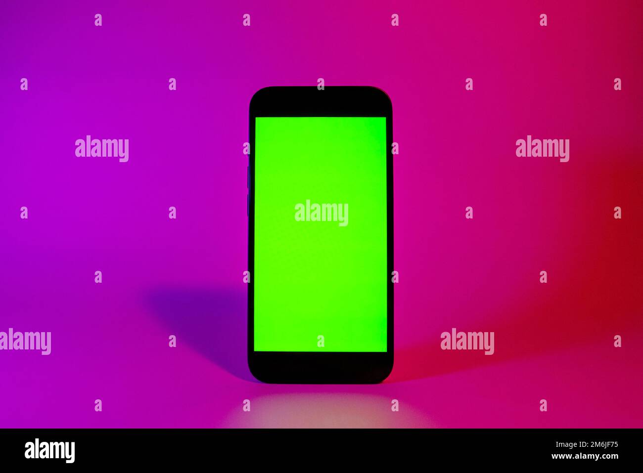 Mobile phone with green screen, smartphone mock up. Neon illumination ...