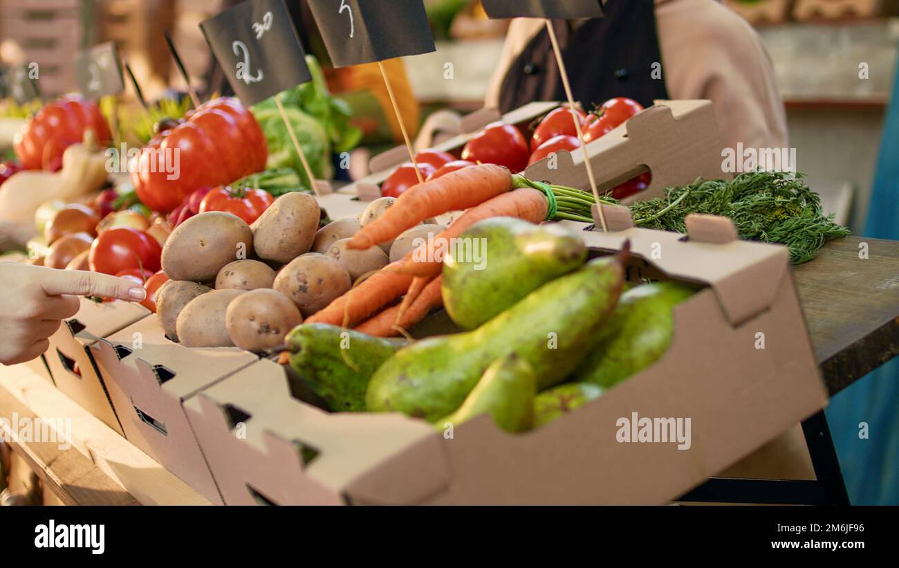 Female consumer choosing organic bio products to buy from local farmers ...