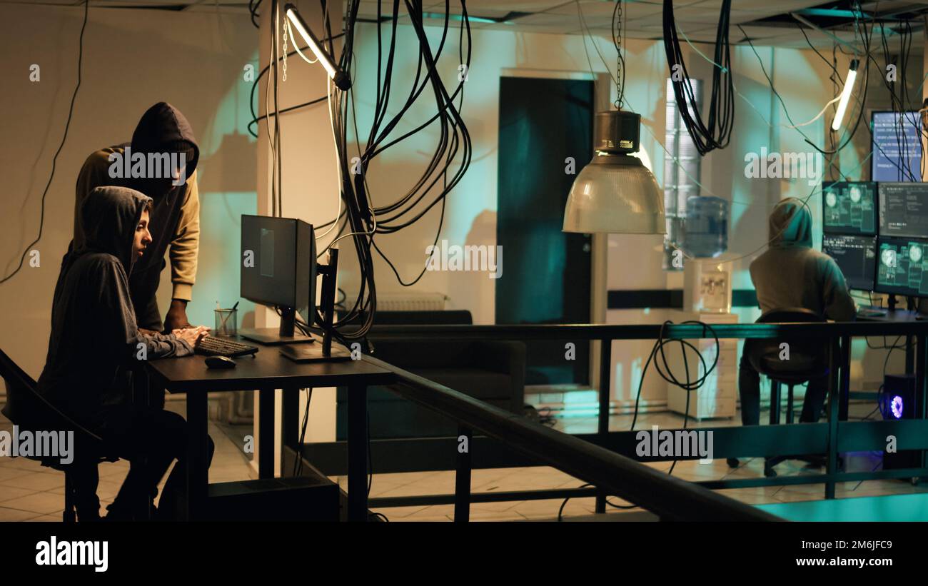 Team of thieves committing cryptojacking or illegal activities on computer system, trying to ...