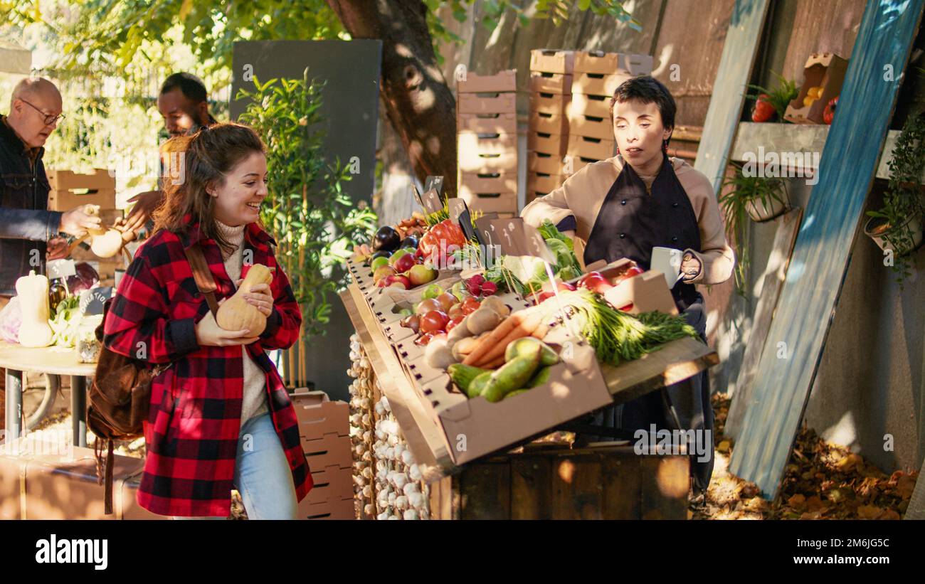 Happy business owner selling bio organic apples to customer, standing ...