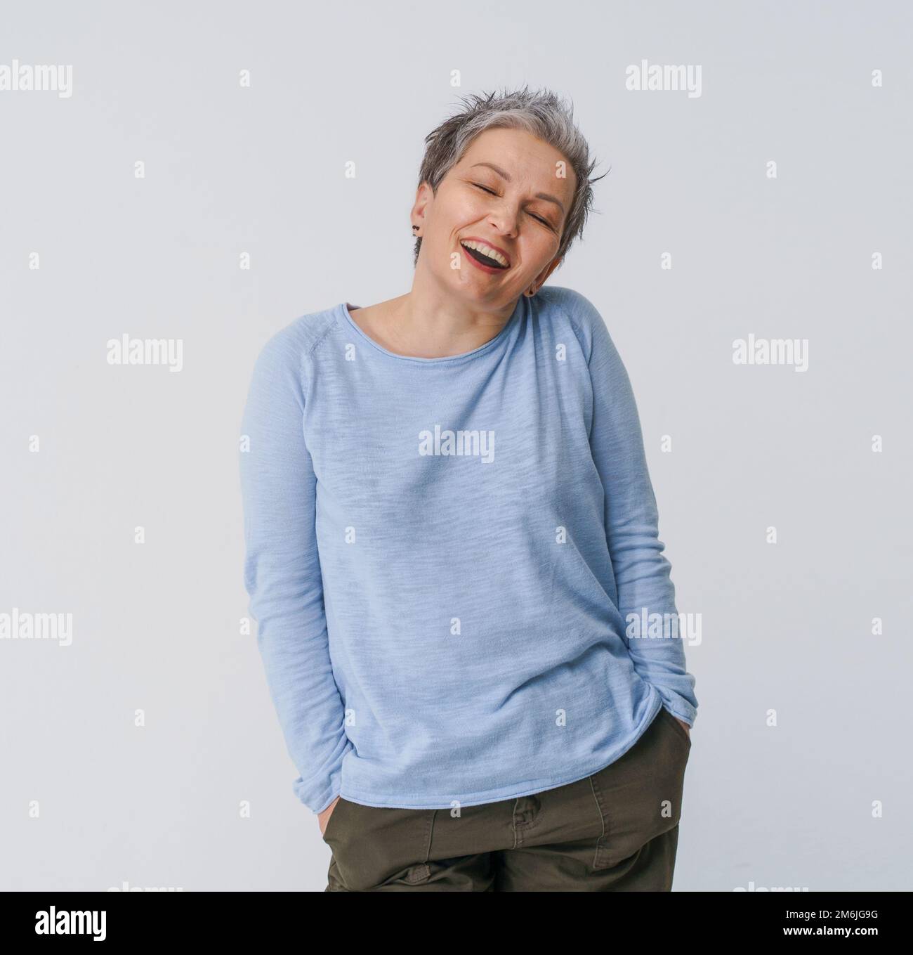 Happy smiling grey hair mature woman 50s posing shoulders slightly up ...