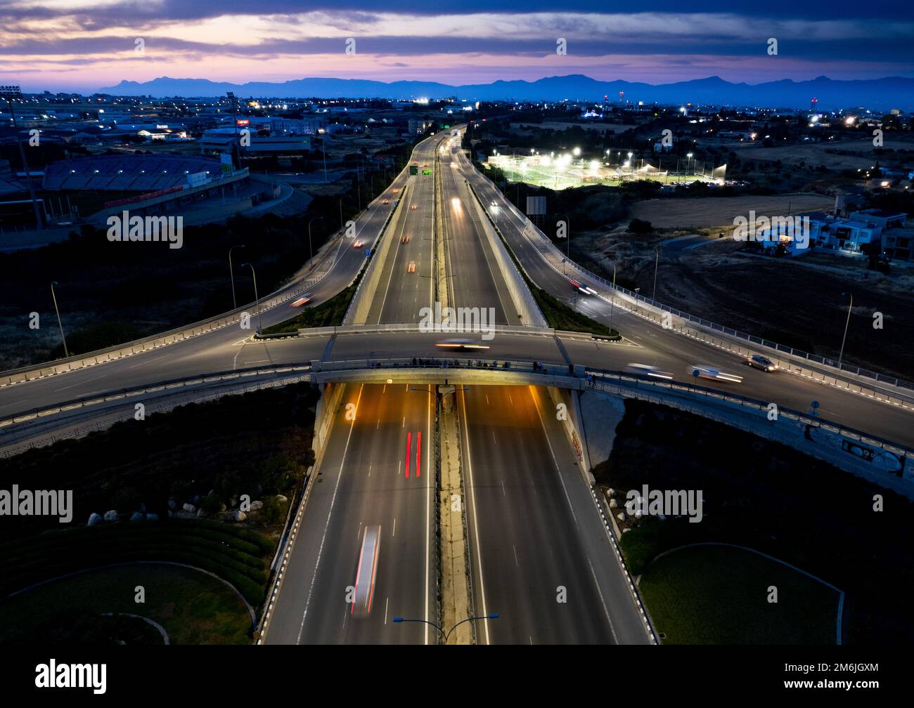 Aerial drone view of highway junction. Roundabout cars moving fast ...