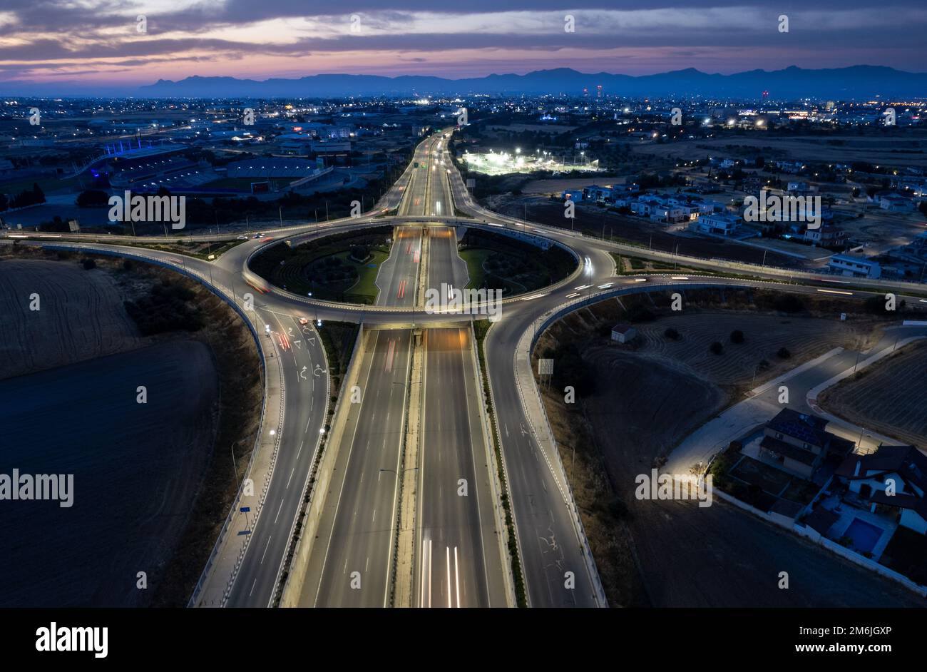 Aerial drone view of highway junction. Roundabout cars moving fast ...