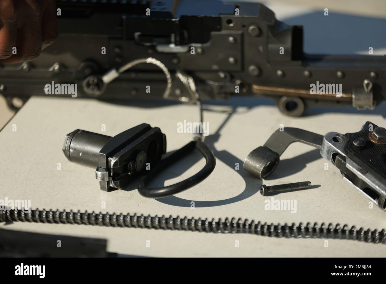 A disassembled M240 machine gun sits on a table during day 4 of the ...
