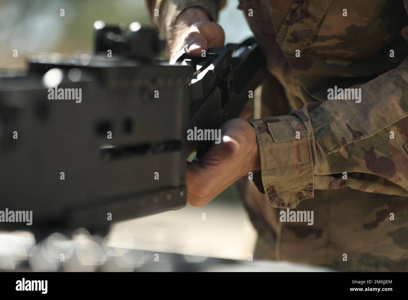 A U.S. Army soldier inserts the bolt group and buffer assembly into an ...