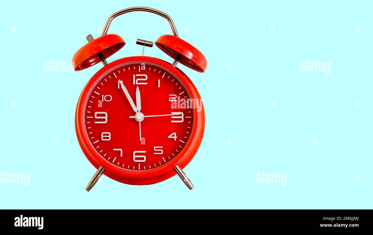 Red alarm clock isolated on light blue colored background Stock Photo ...