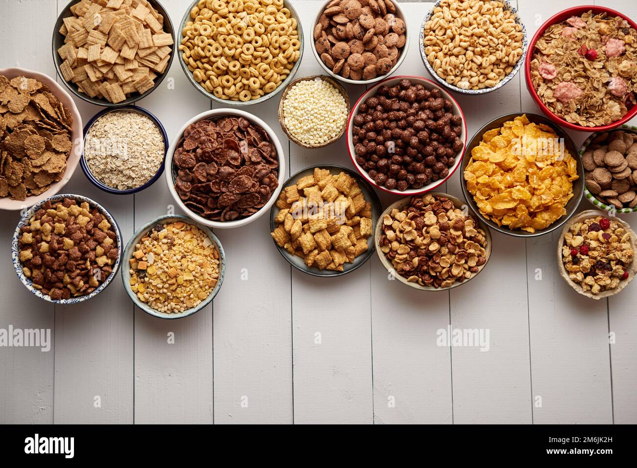 Assortment of different kinds cereals placed in ceramic bowls on table ...