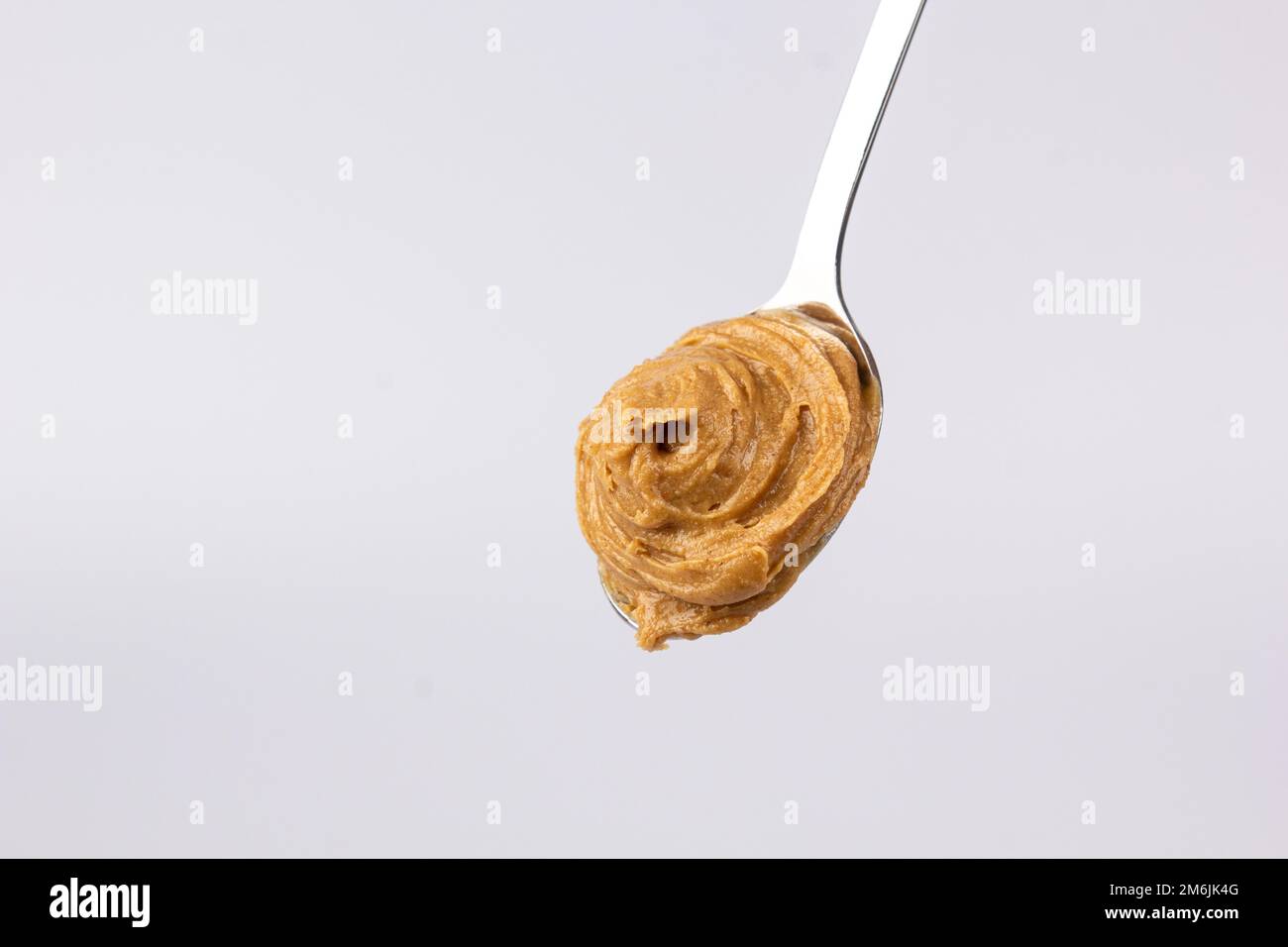 Delicious creamy peanut butter is laid out in a beautiful slide in a ...