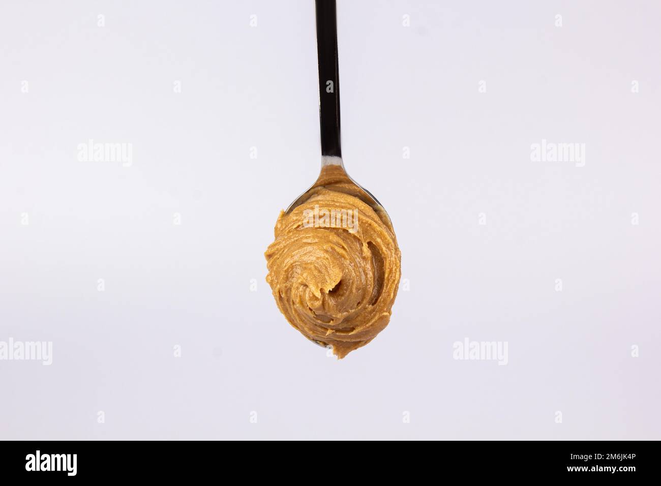 Delicious creamy peanut butter is laid out in a beautiful slide in a ...